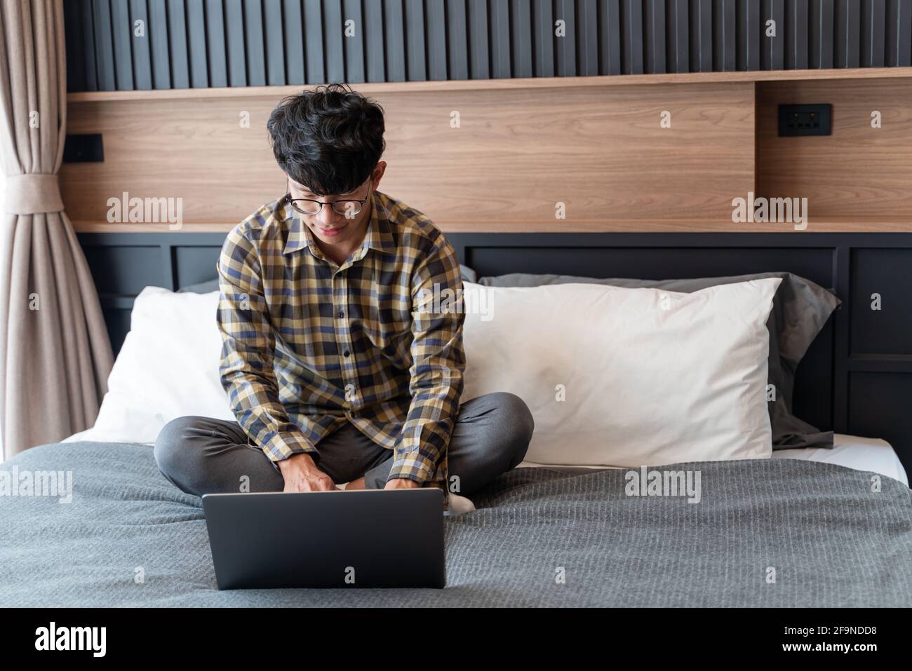 work from home, A Checkered shirt man who wearing eye glasses sit on ...