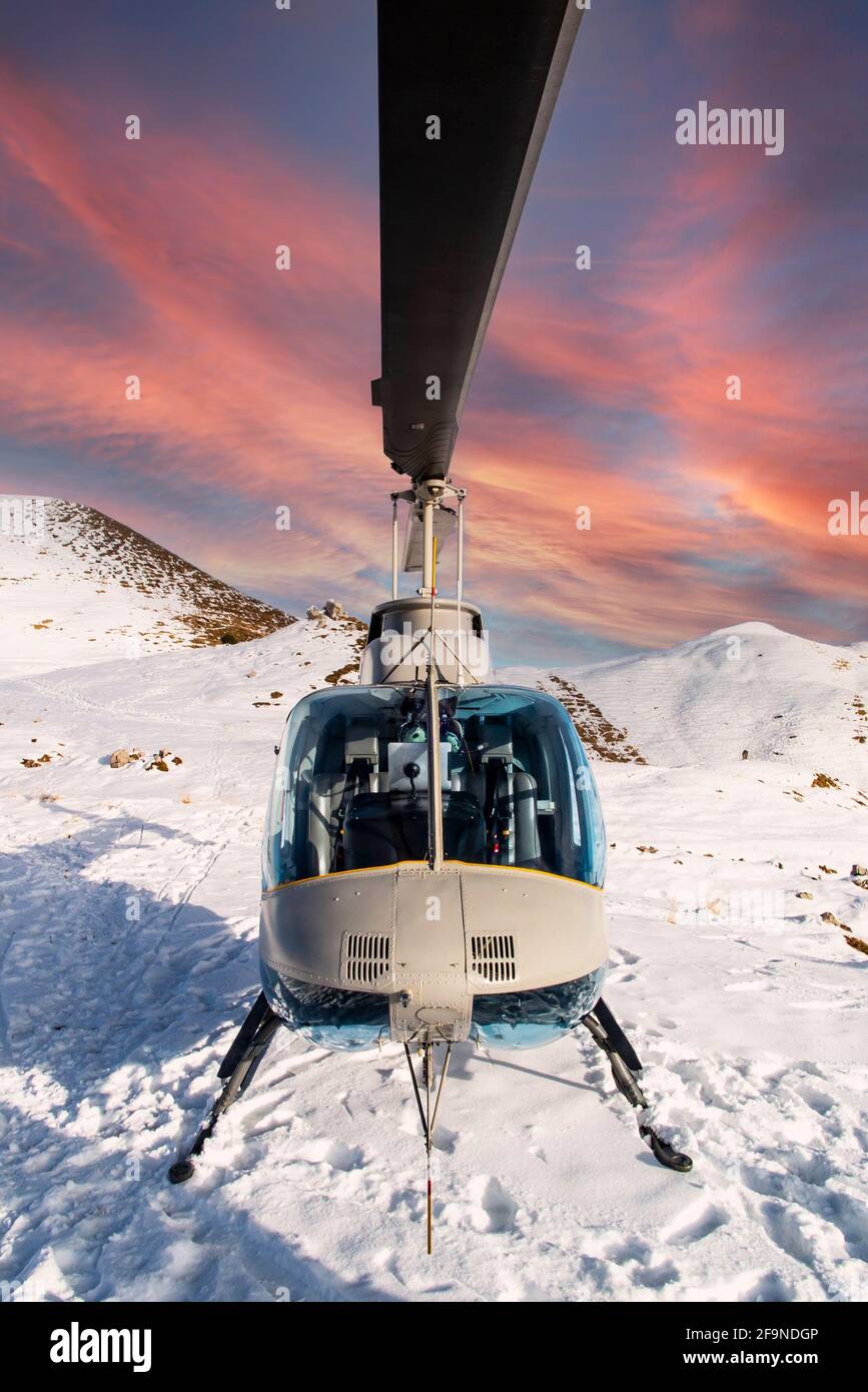 Helicopter in the alps at sunset Stock Photo - Alamy