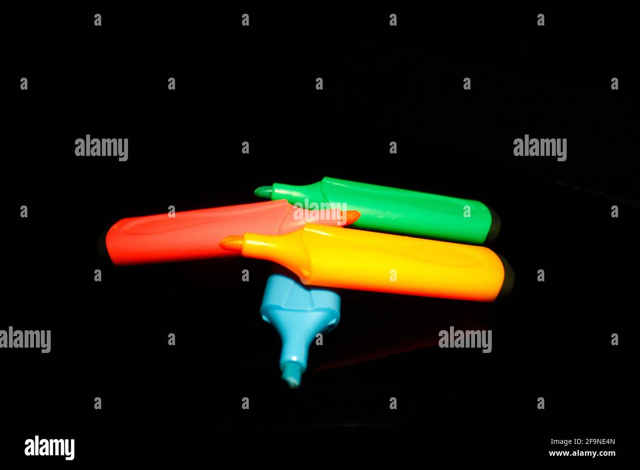 A stack of four marker pen isolated on black Stock Photo - Alamy