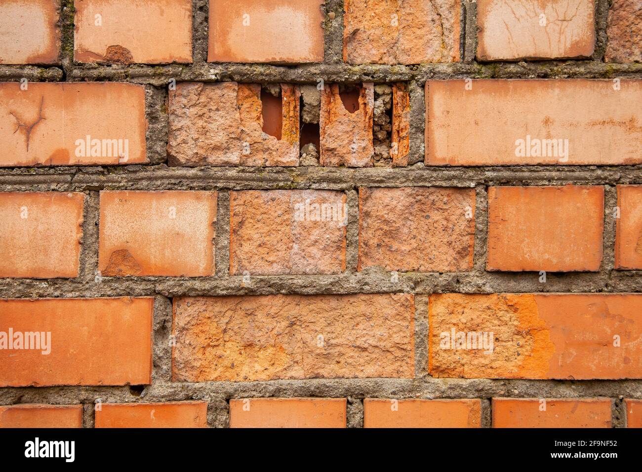 Old brick wall made of red bricks. Breaking down a wall falling apart ...