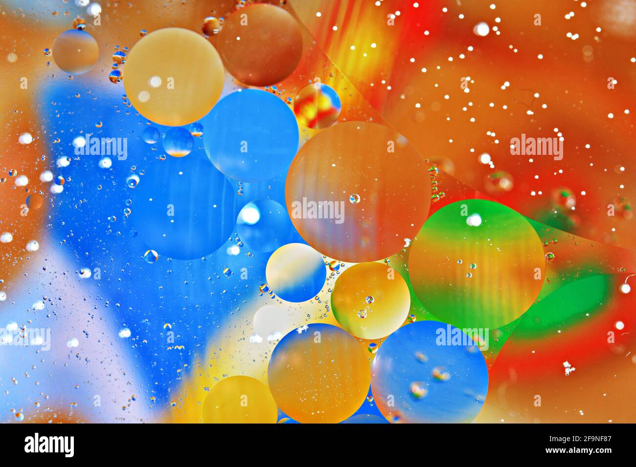 Colorful bubbles from oil in water in a macro shot Stock Photo - Alamy