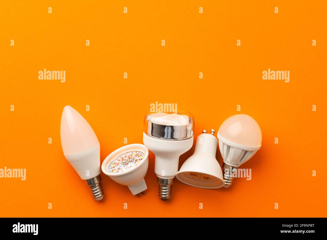 Light bulb on bright orange background top view Stock Photo - Alamy
