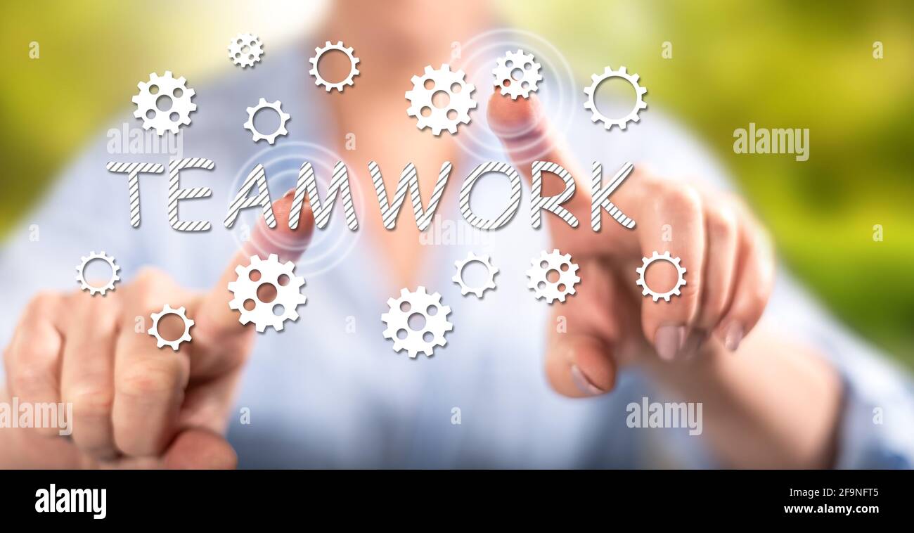 Woman touching a teamwork concept on a touch screen with her fingers ...