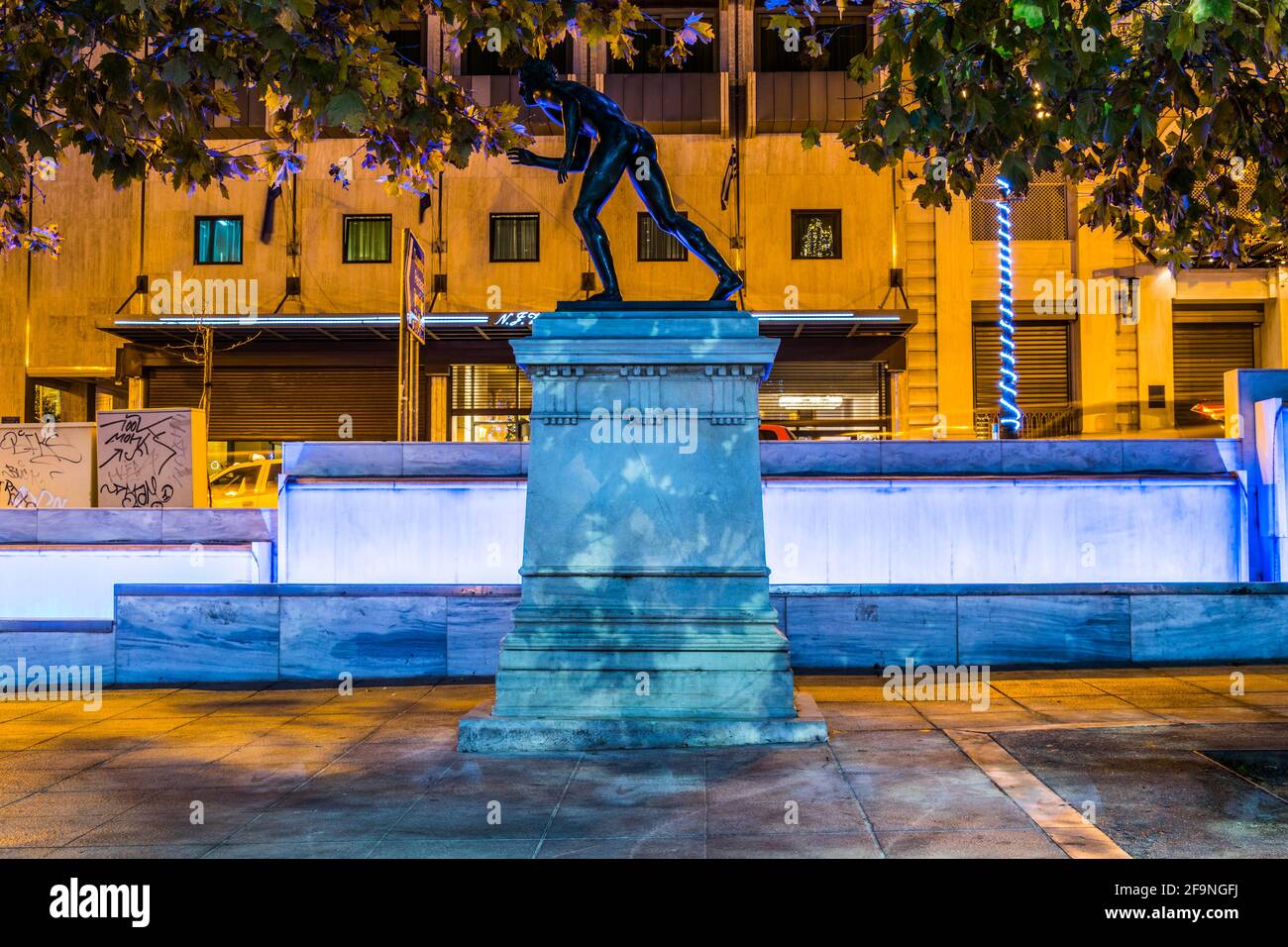 night view of statue of a running boy situated on the sytagma square in ...
