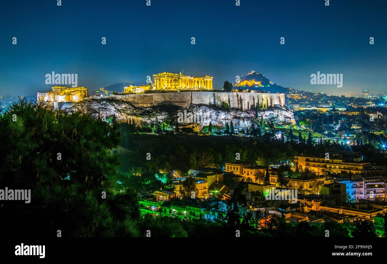 Parthenon and Herodium construction in Acropolis Hill in Athens, Greece shot in blue hour with ...