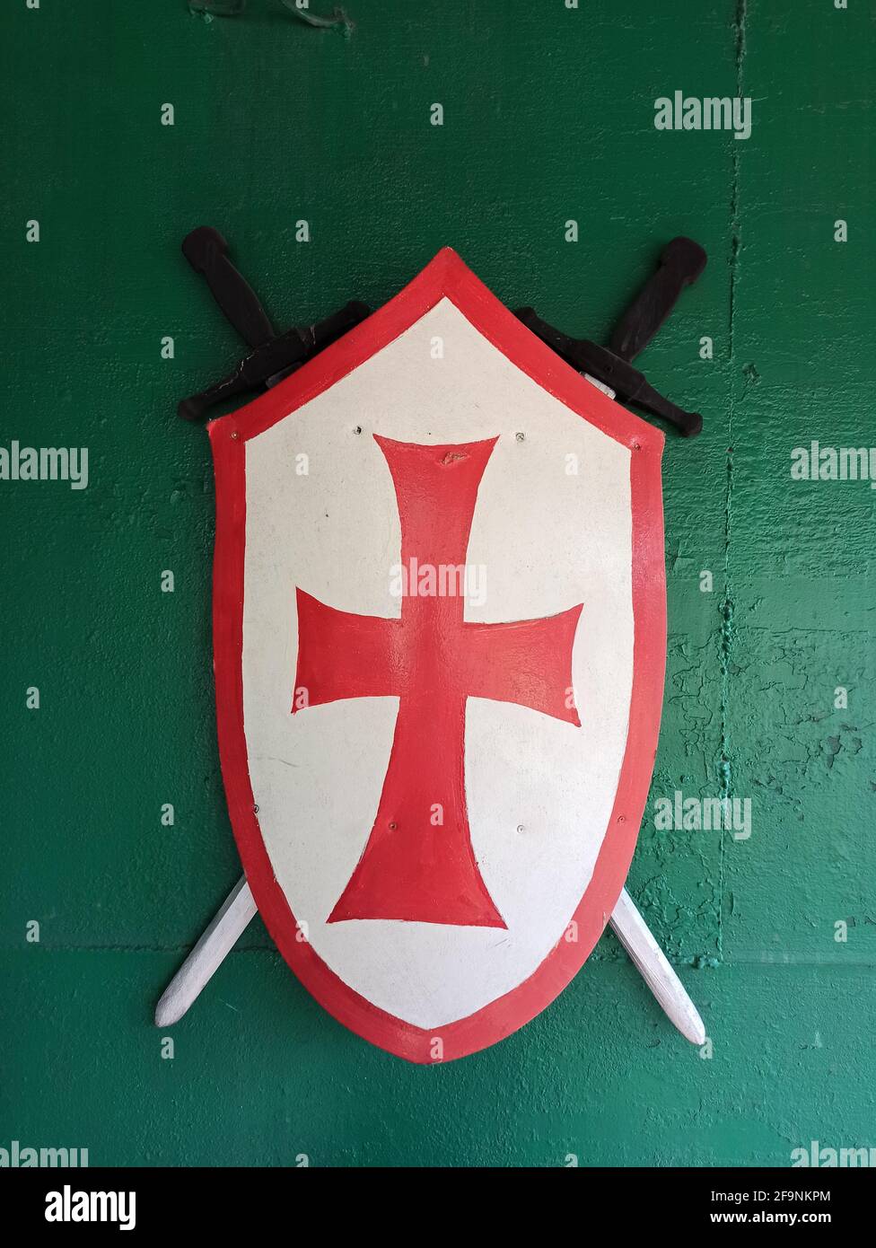 Shield with a red cross and two swords. Wooden copies of the shield and ...