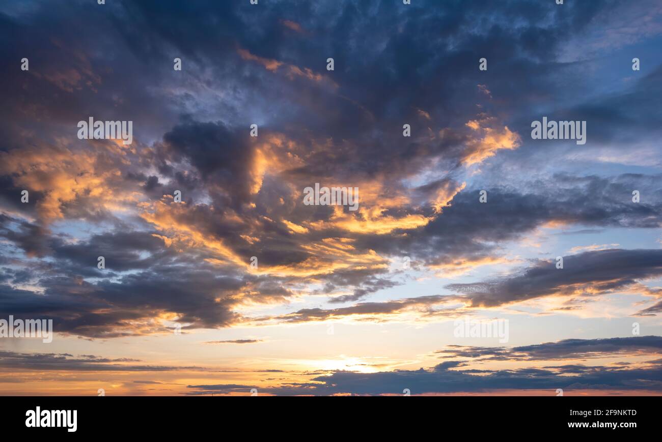 Sunset sky with clouds in blue and orange colors Stock Photo - Alamy