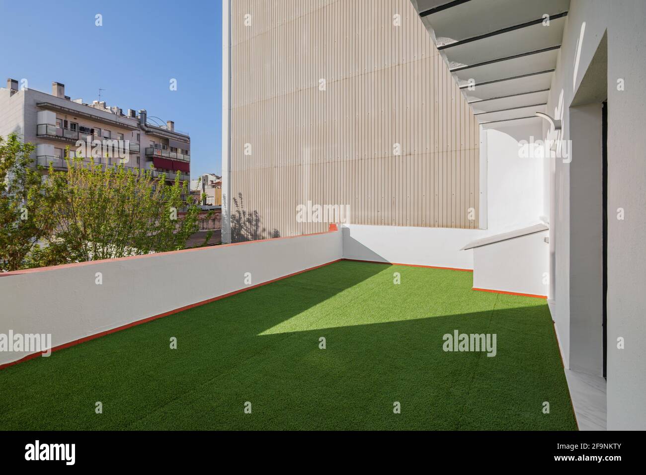 Empty sunny terrace of refurbished apartment with artificial green ...