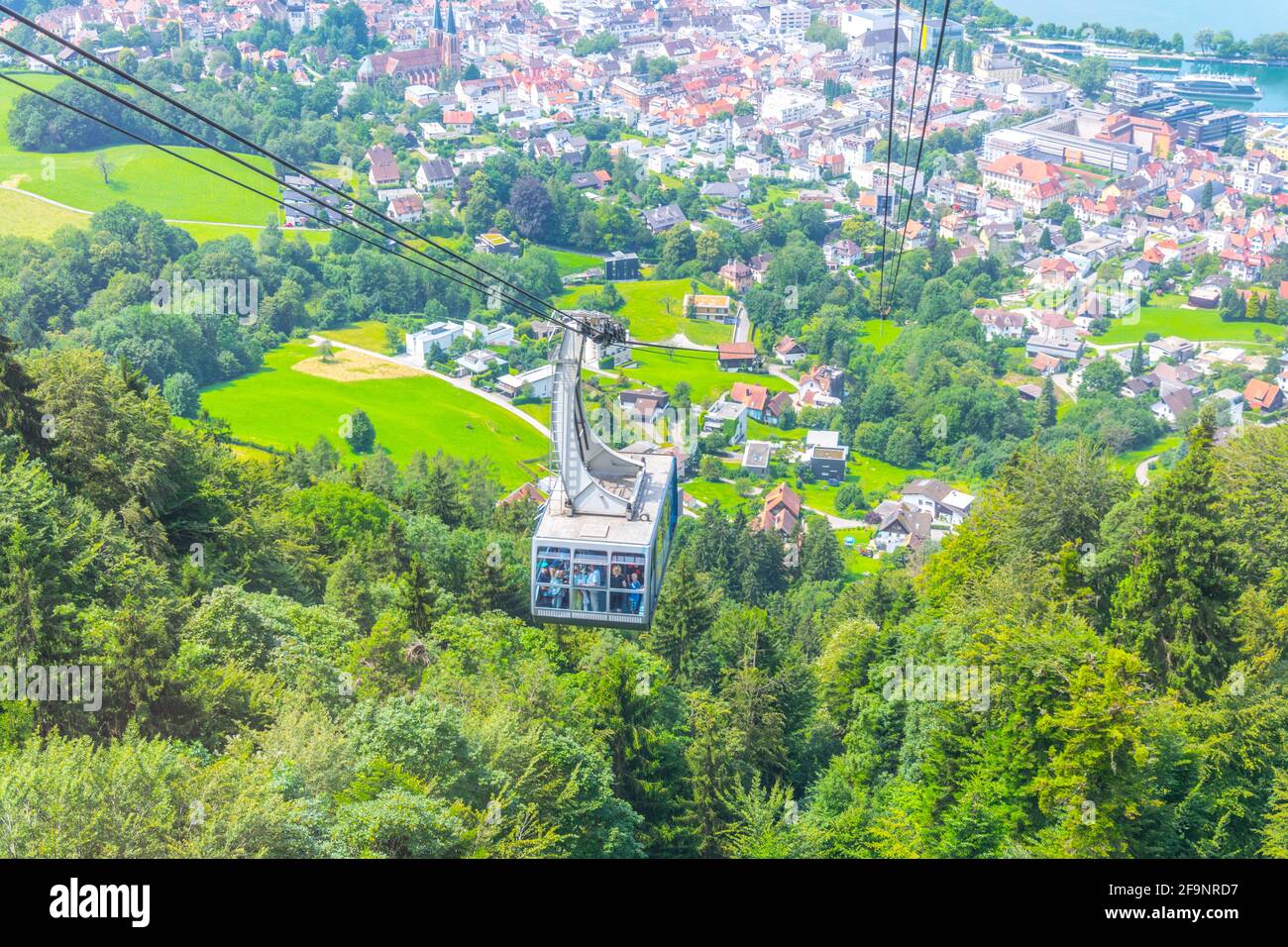 View of a pfanderbahn cable car with the Austrian city Bregenz behind ...