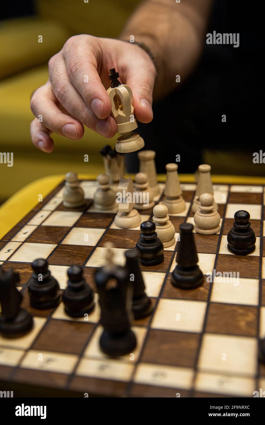 Man taking next step on chess game. Human hand moving wooden white ...