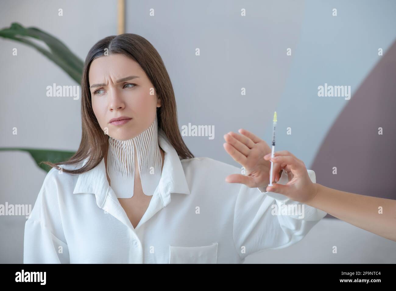 Cute young woman visiting beauty center and rejectong botox injections ...