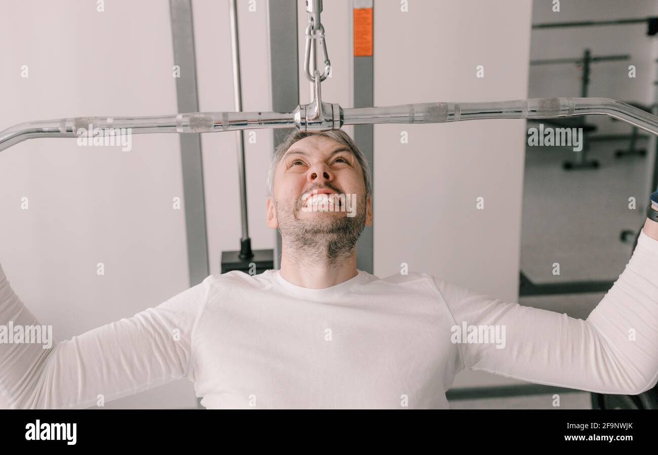 novice bodybuilder performs traction exercises on the simulator Stock ...