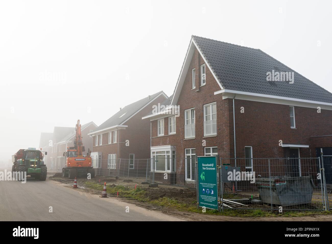 Almost finished new built houses in the mist at construction site in ...