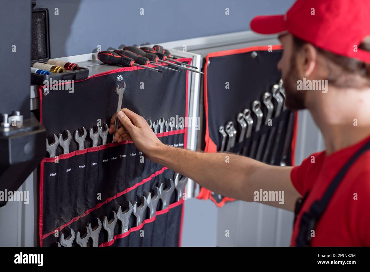 Man in work clothes picking wrench Stock Photo - Alamy