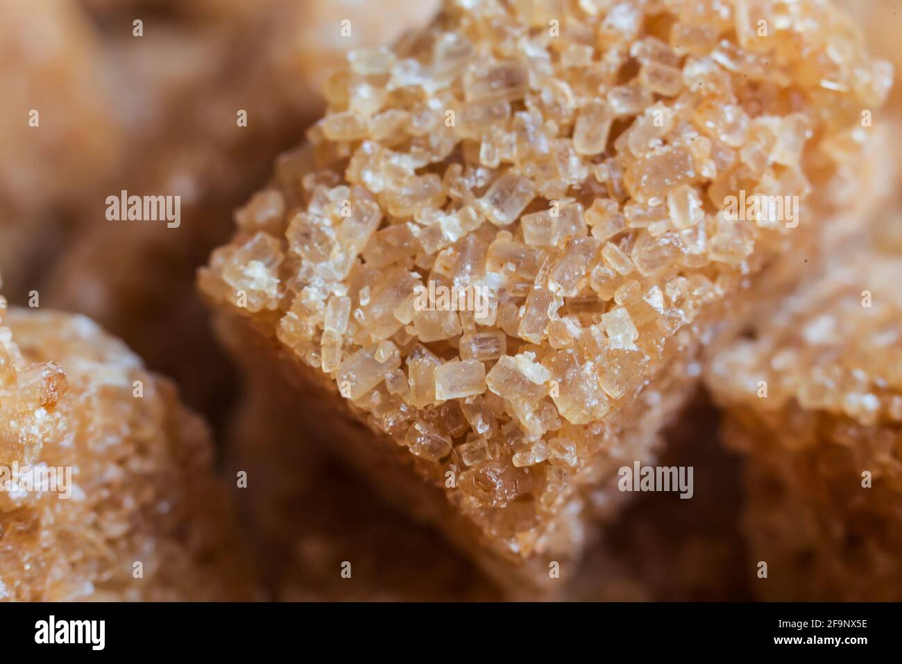 Square lumps of brown pressed cane sugar. Close-up Stock Photo - Alamy