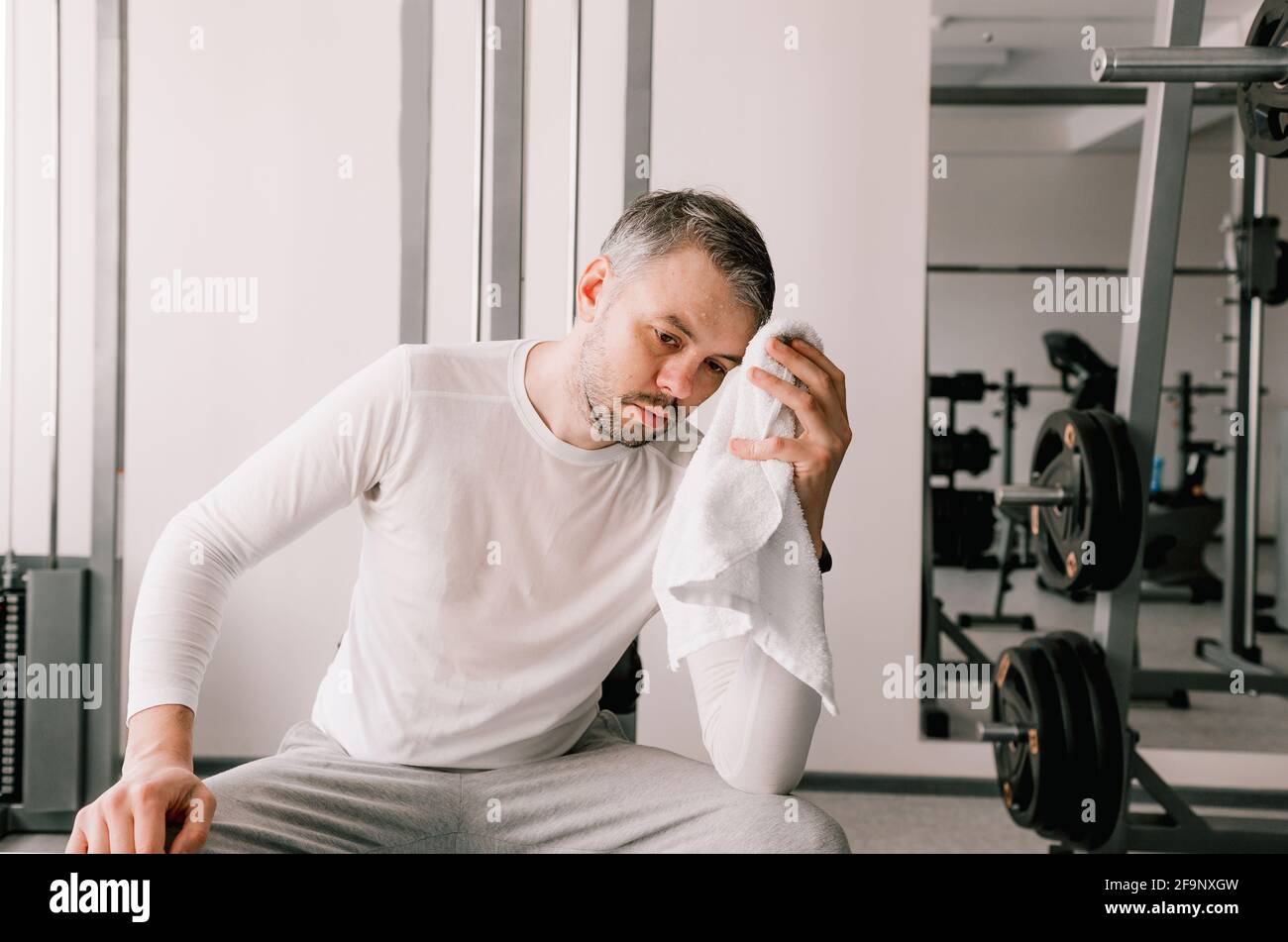 Tired man after workout sits hi-res stock photography and images - Alamy