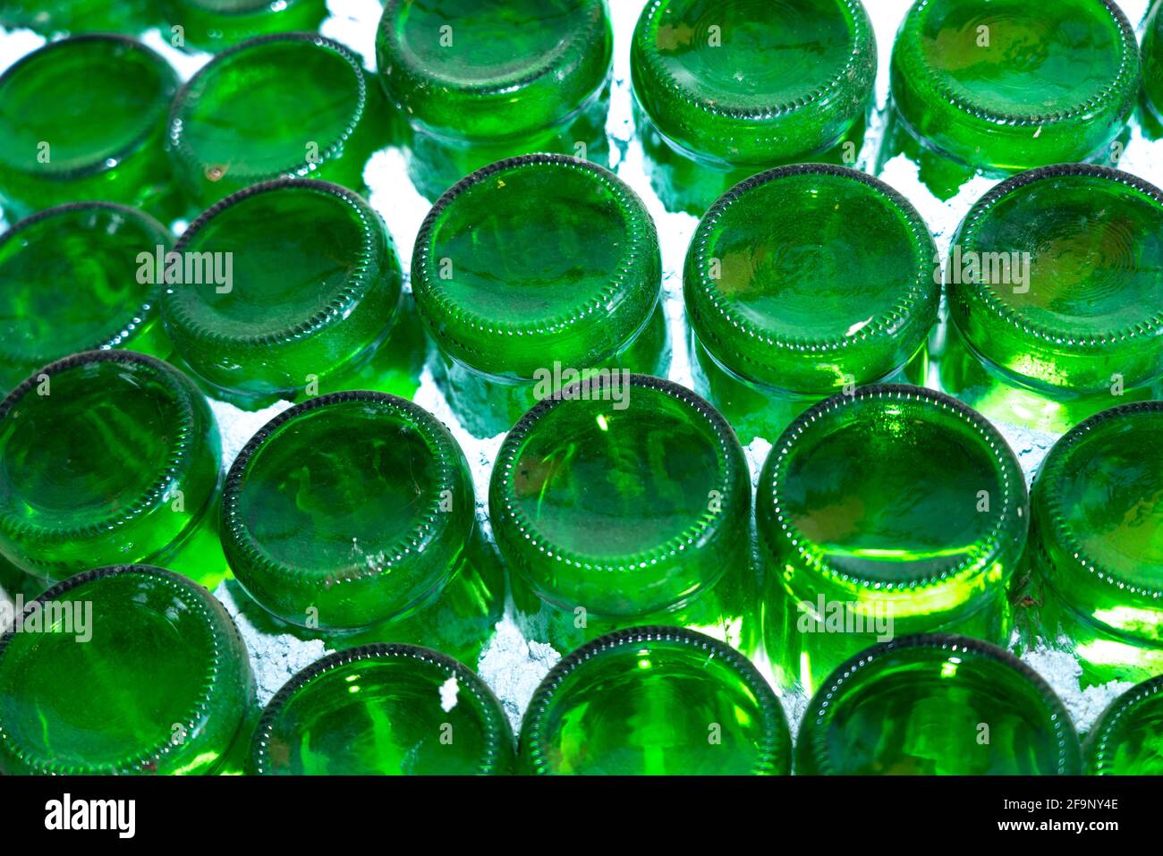 Green bottles in white wall abstract background Stock Photo - Alamy