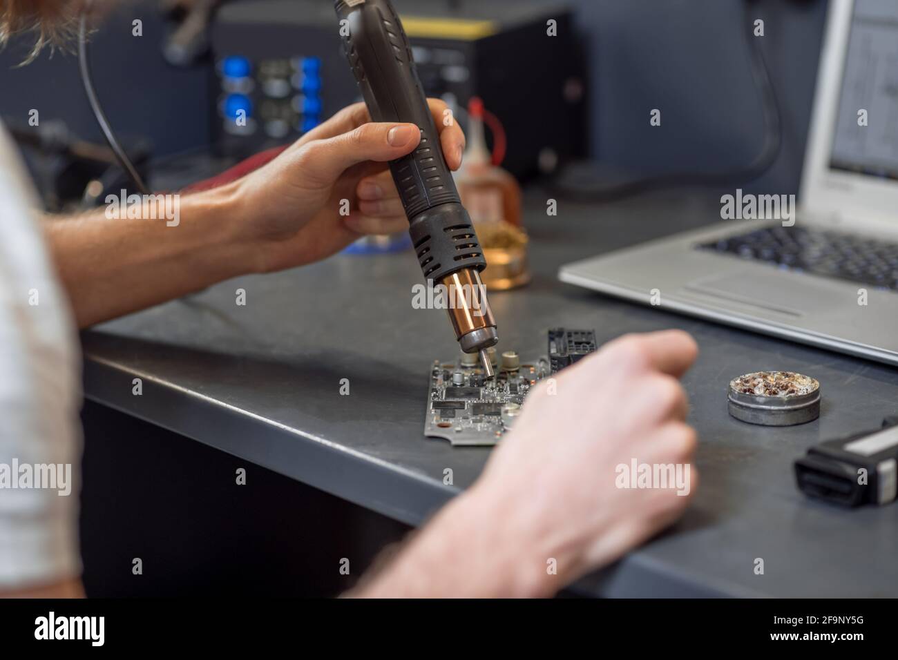 Male hands soldering microcircuit on table near laptop Stock Photo - Alamy
