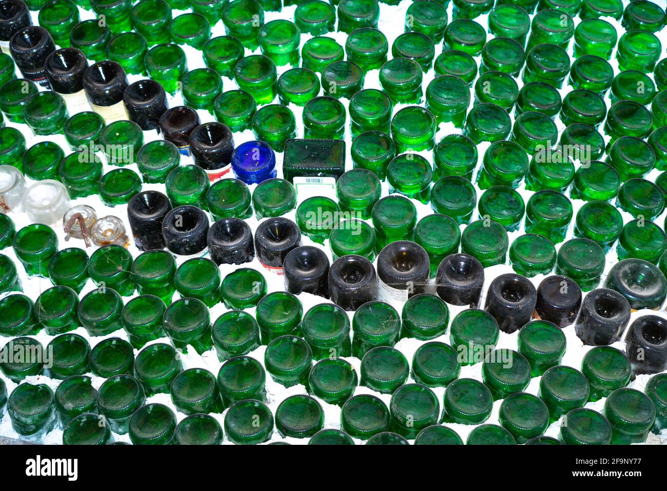 Green bottles in white wall abstract background Stock Photo - Alamy