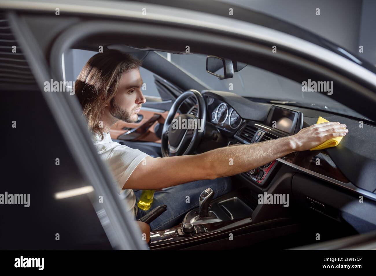 Man sitting in drivers seat of car Stock Photo - Alamy