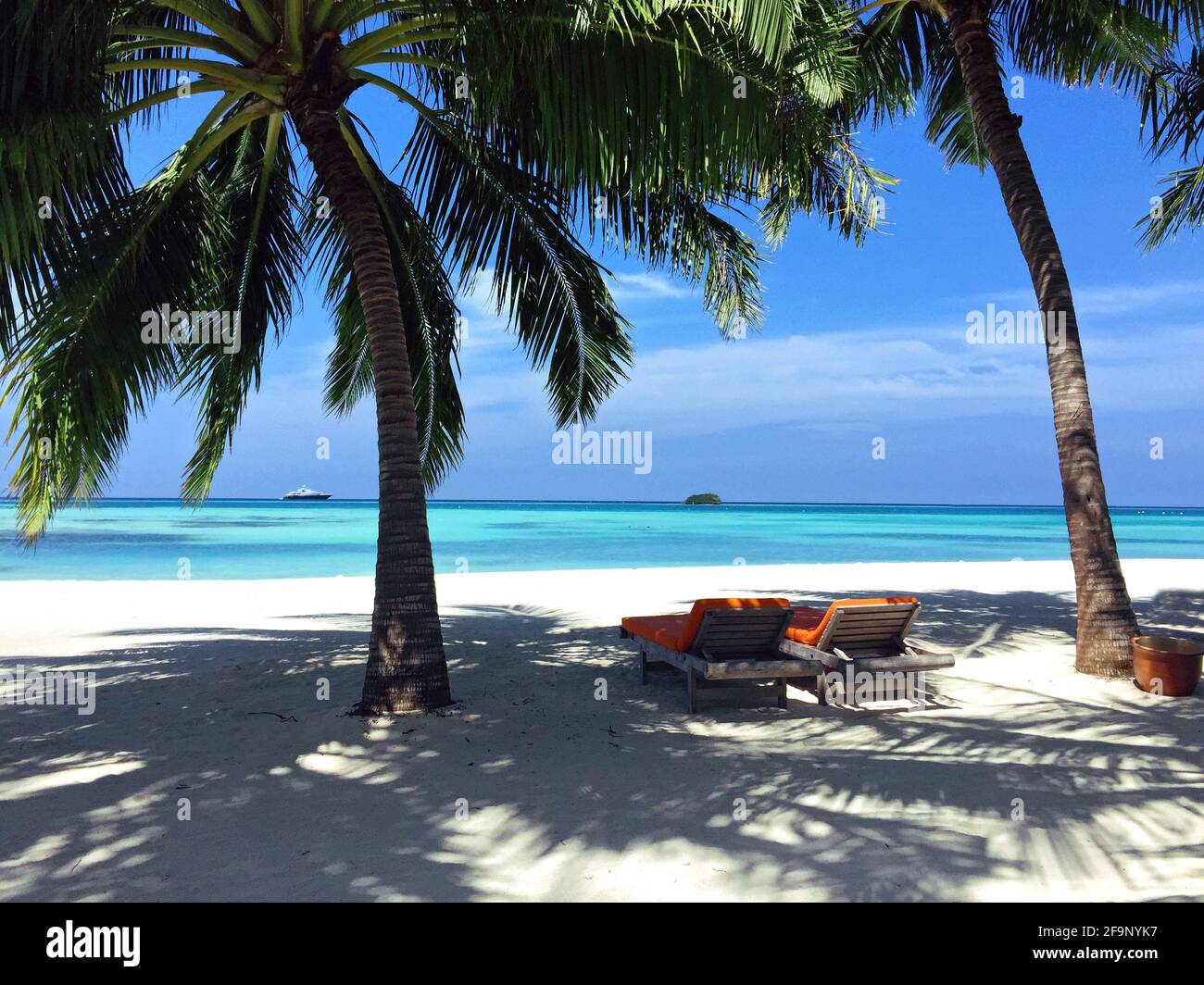 Ocean view from a Maldives beach with two sun beds Stock Photo - Alamy
