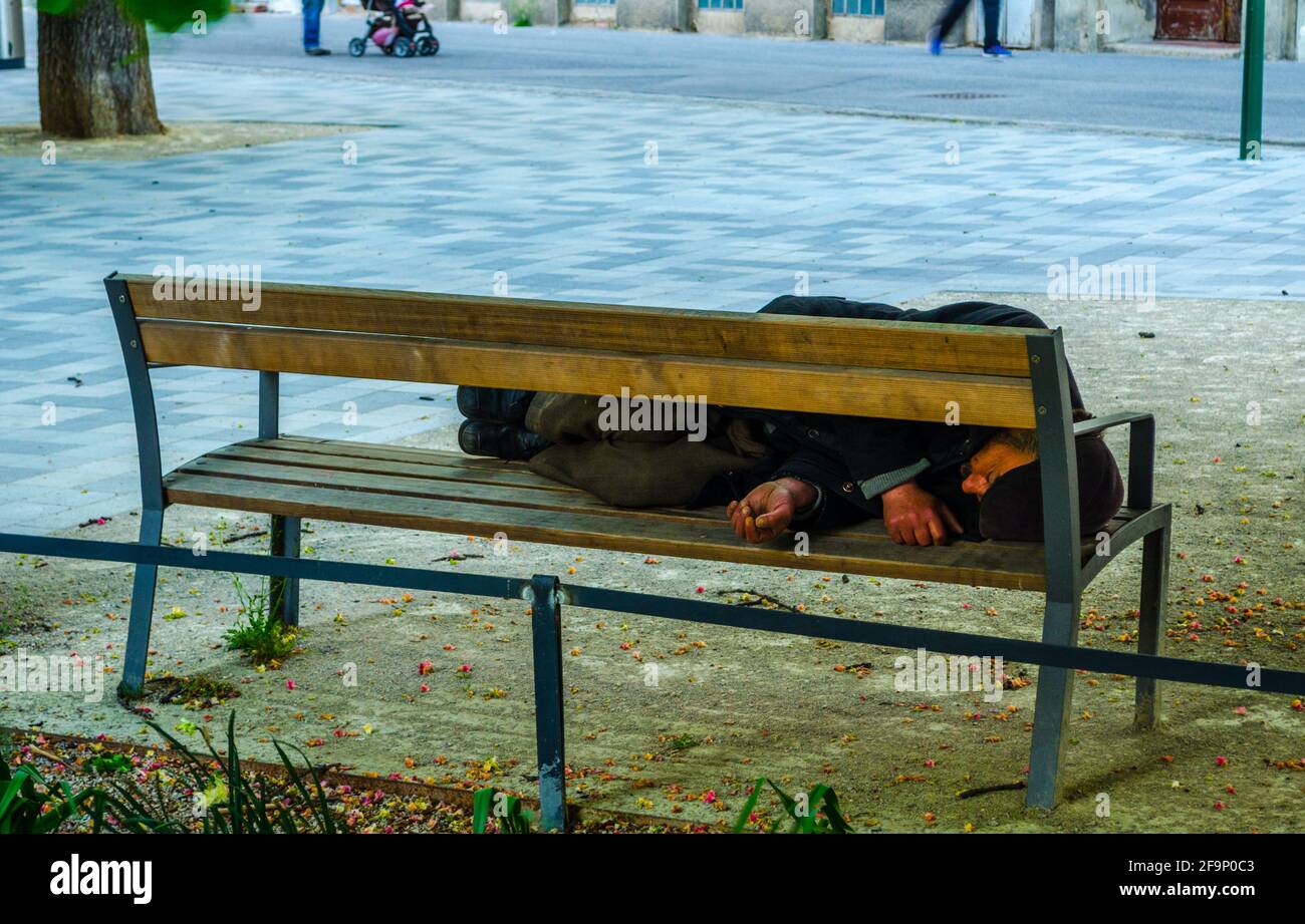Homeless person is sleeping on a bench in the center of vienna, austria ...