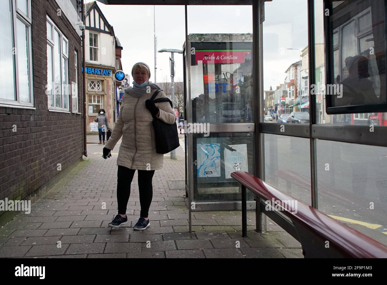 Woman waiting at bus stop hi-res stock photography and images - Alamy