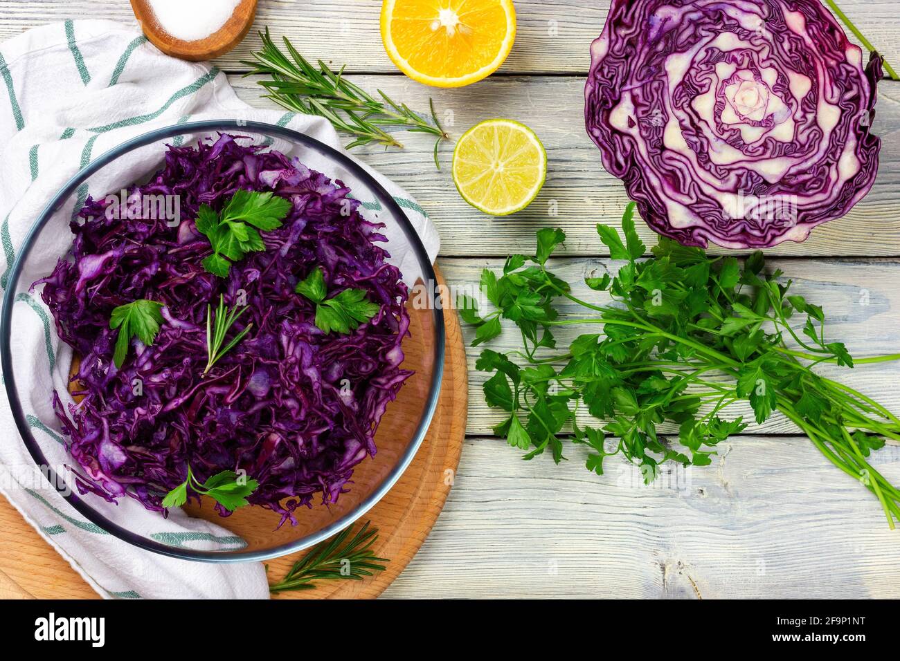 Purple cabbage salad in a glass bowl. The process of preparing a ...