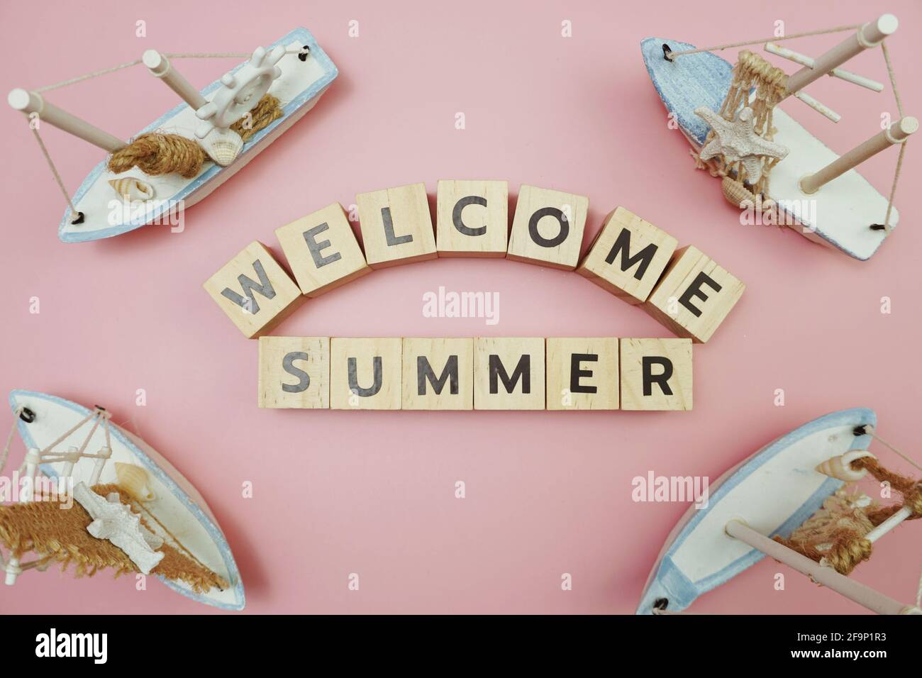 Welcome Summer message alphabet letter with sailboat on pink background ...