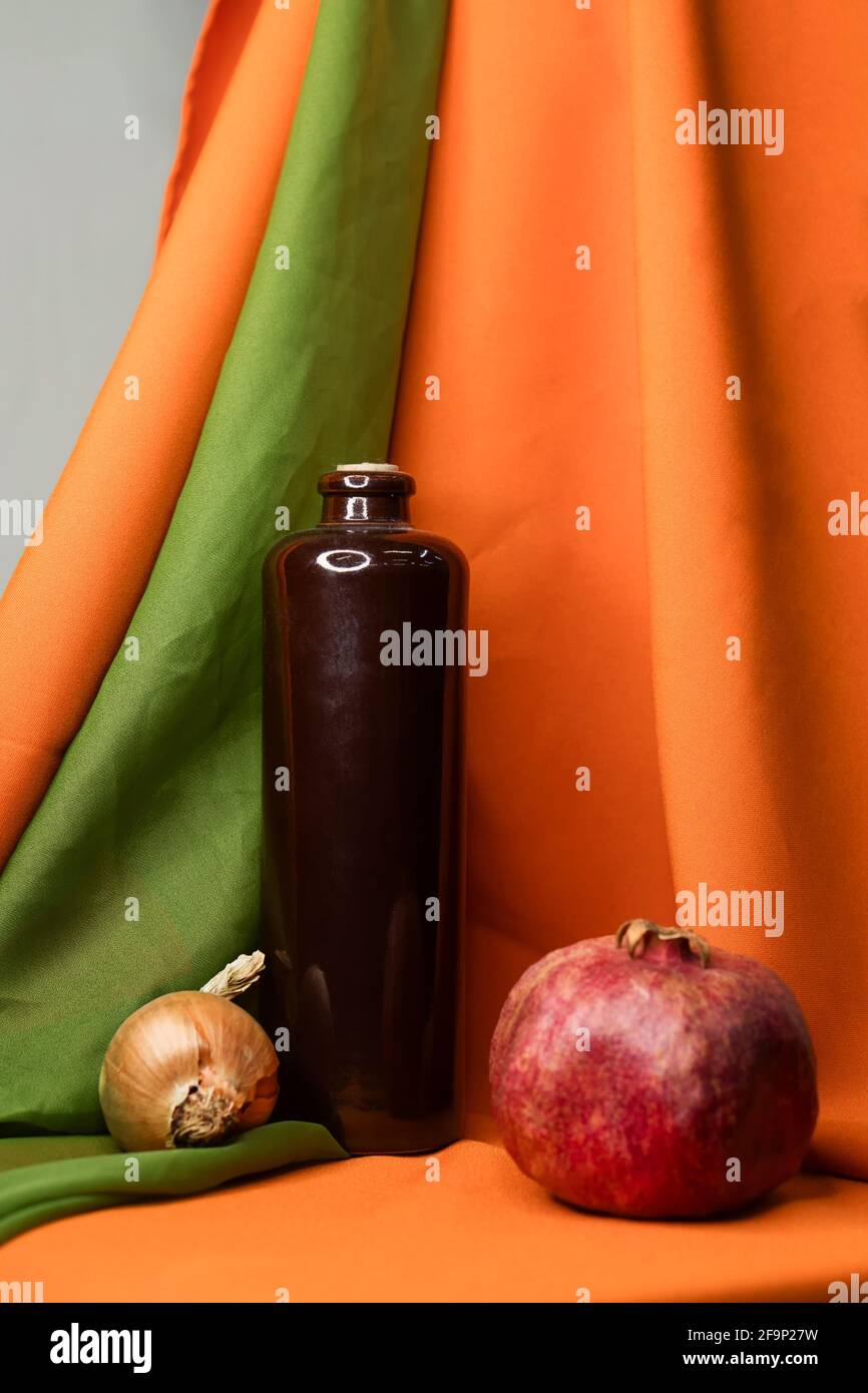 Educational still life for drawing. Dark glass bottle, pomegranate and ...
