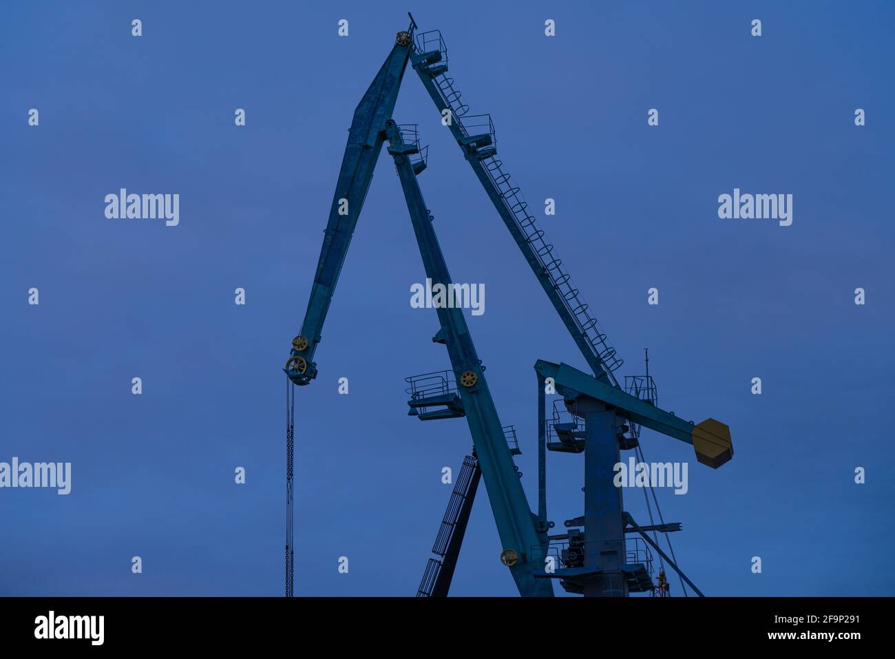 Crane on blue sky background Stock Photo - Alamy