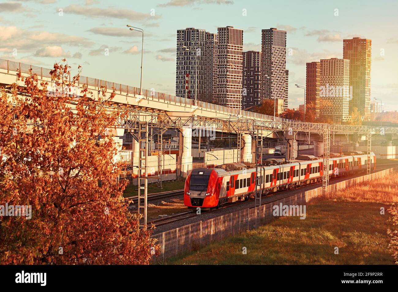 Passenger train rides by rail in modern city Stock Photo - Alamy