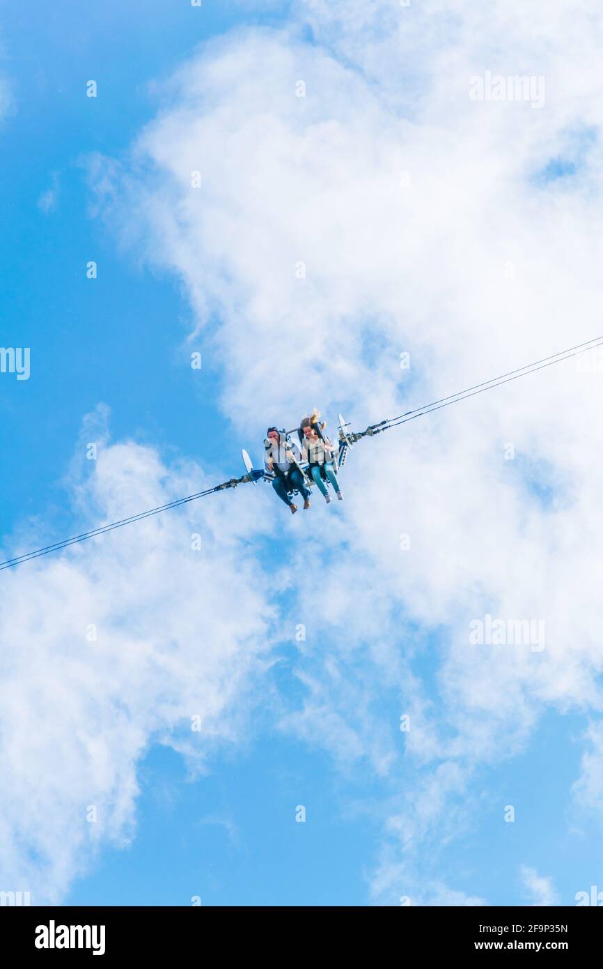 Detail of people levitating in the air on a thrilling attraction inside ...