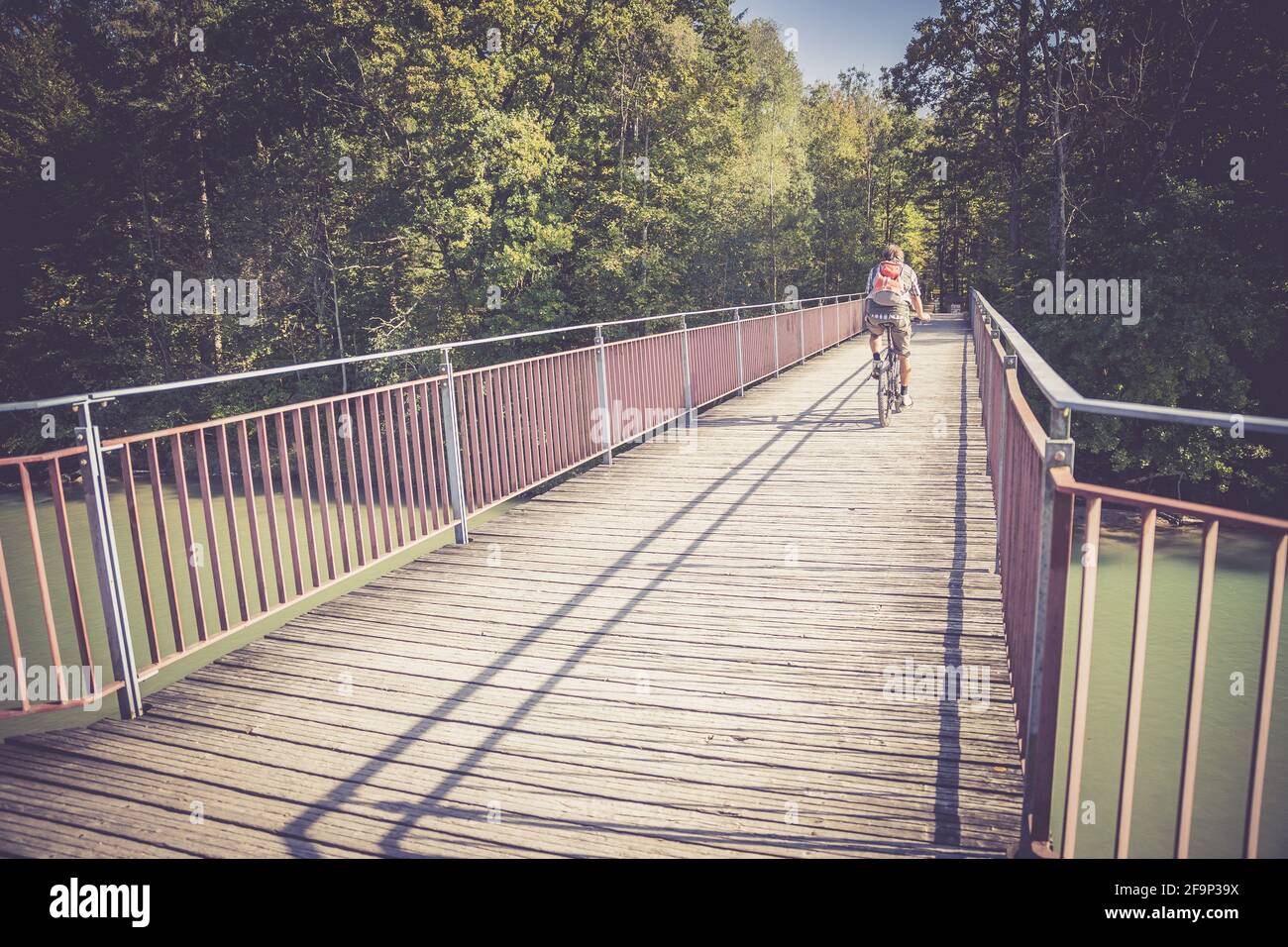 Wooden bridge over a river in spring time Stock Photo - Alamy