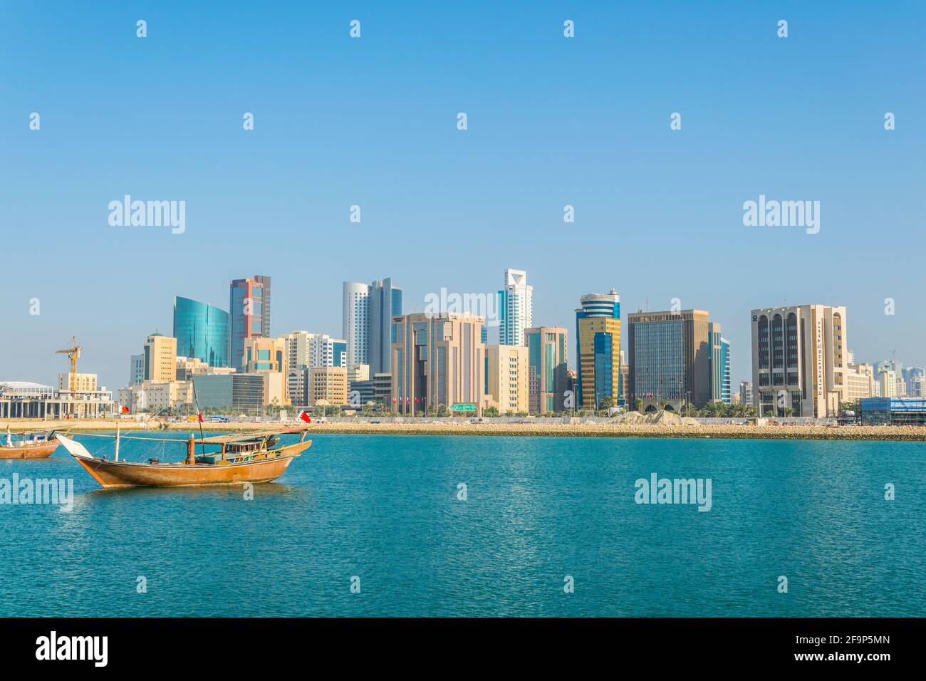 Skyline of Manama with a dhow boat, Bahrain Stock Photo - Alamy
