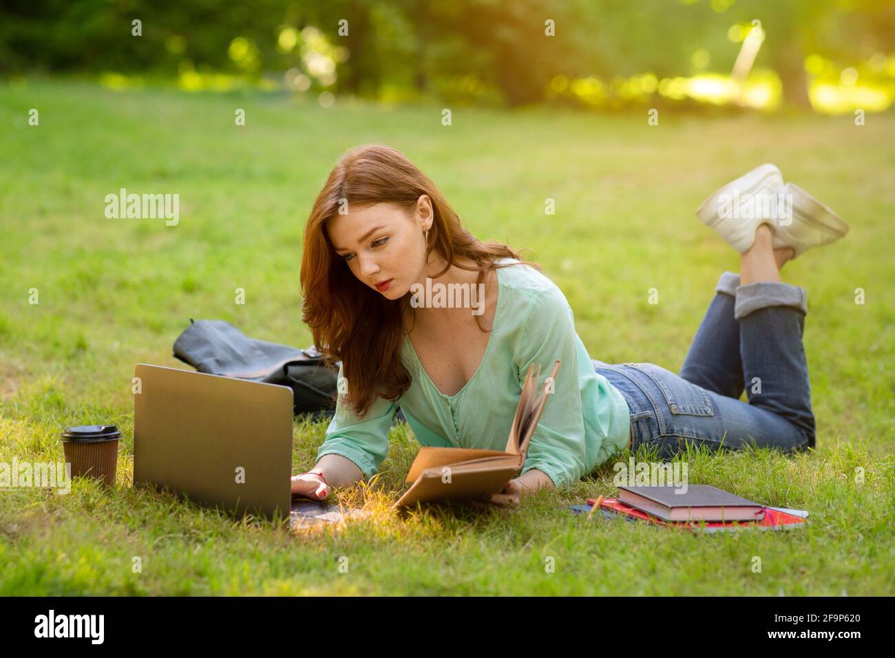 Focused Redhead High-School Student Girl Doing Homework With Laptop And ...