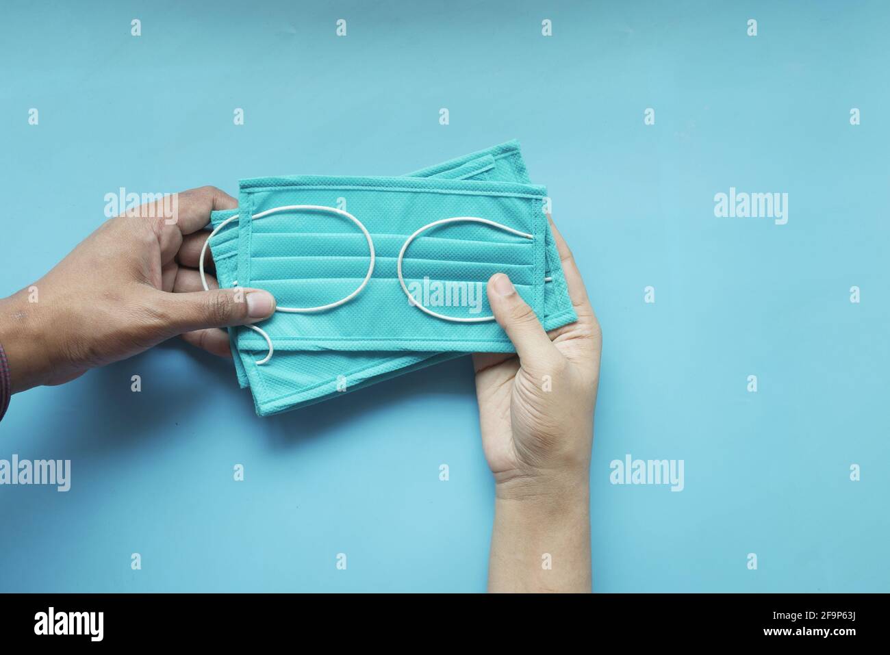 hand holding surgical face mask, top view Stock Photo - Alamy