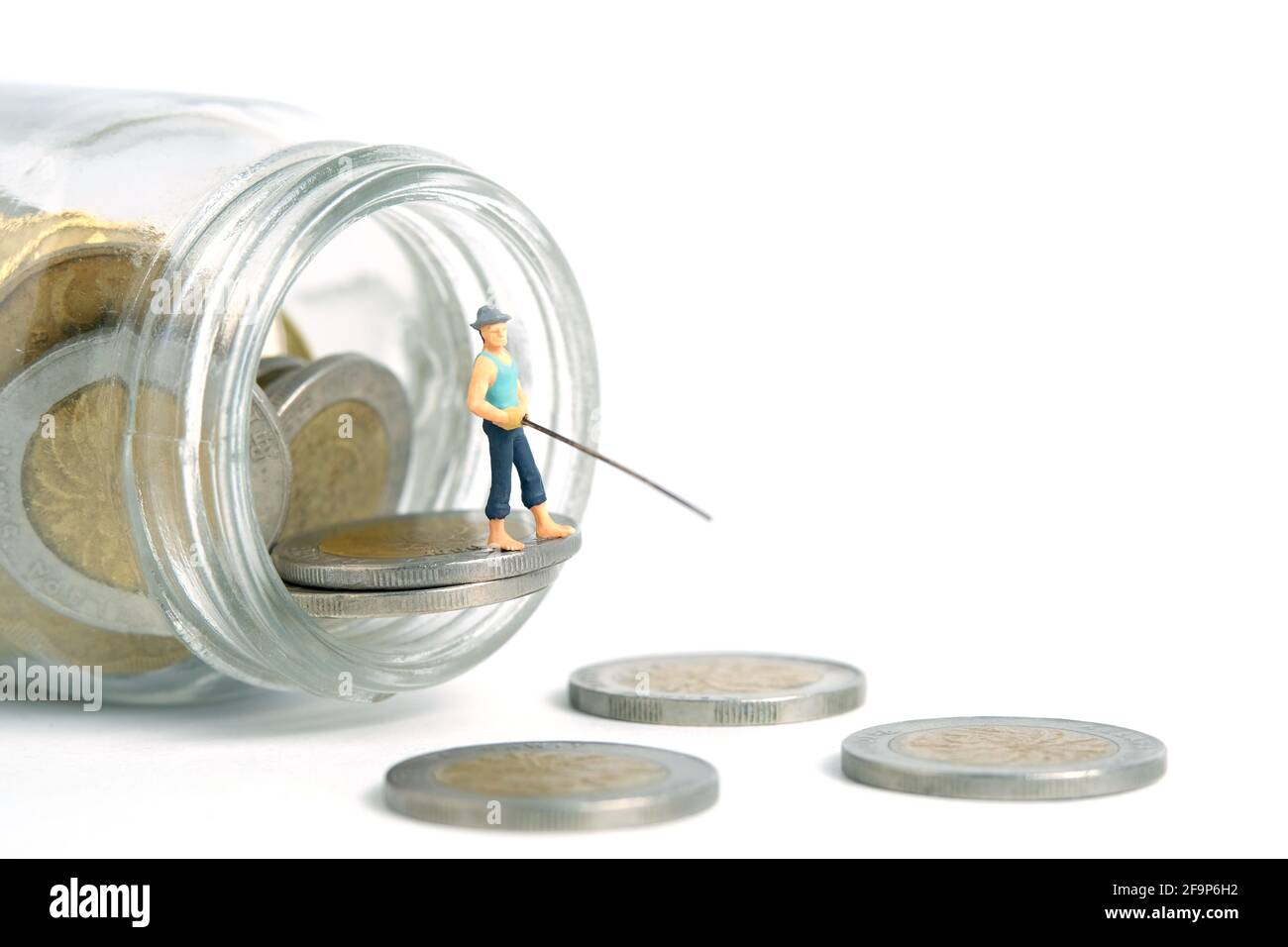 Miniature people toy photography. An angler standing above money jar ...