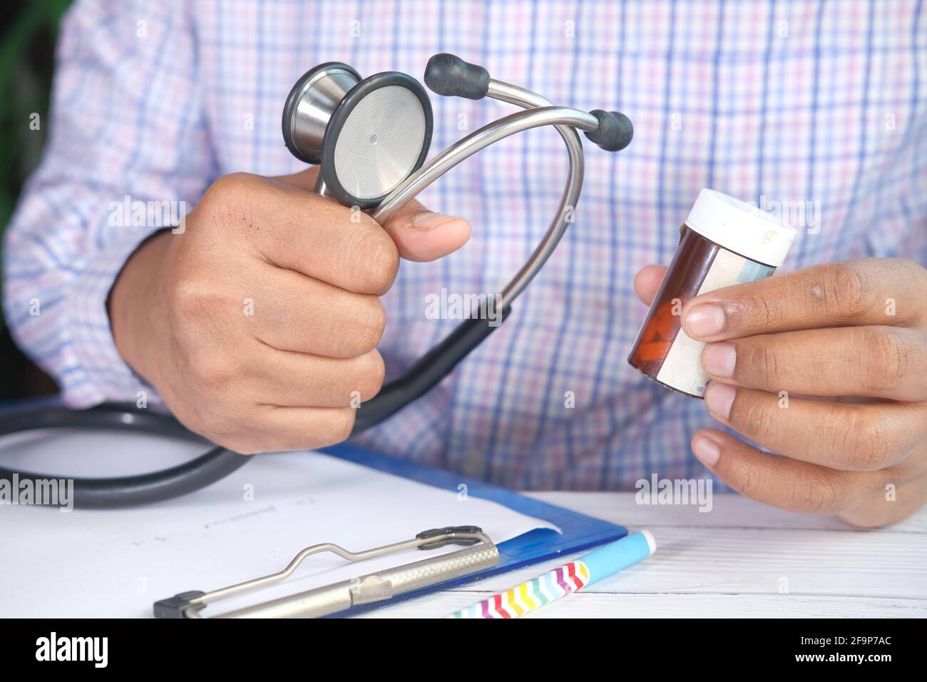 doctor hand holding pill container with copy space Stock Photo - Alamy