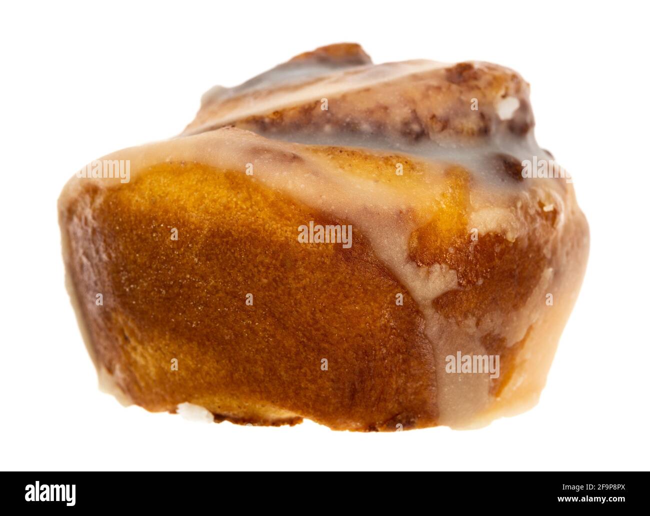 Side view of a single bite size cinnamon swirl roll isolated on a white ...
