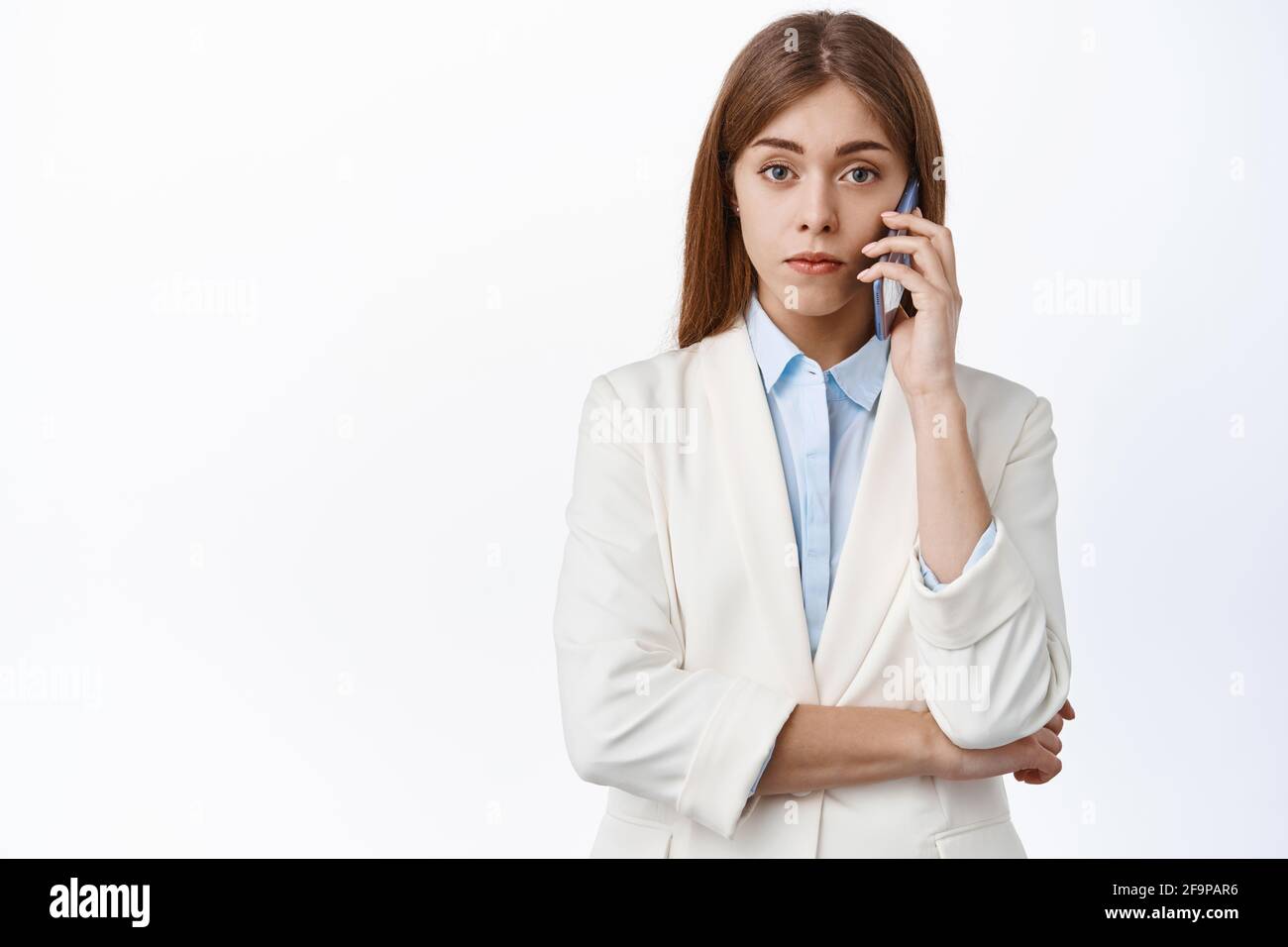 Serious ceo woman in business suit talks on phone. Professional female ...