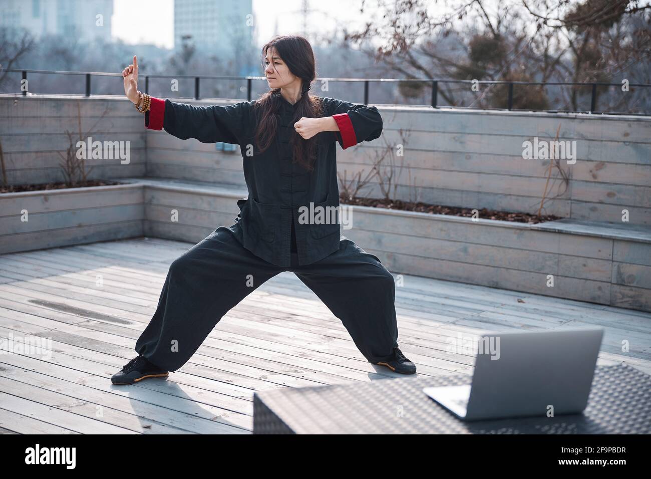 Female turned left in wushu form ready for punch Stock Photo - Alamy