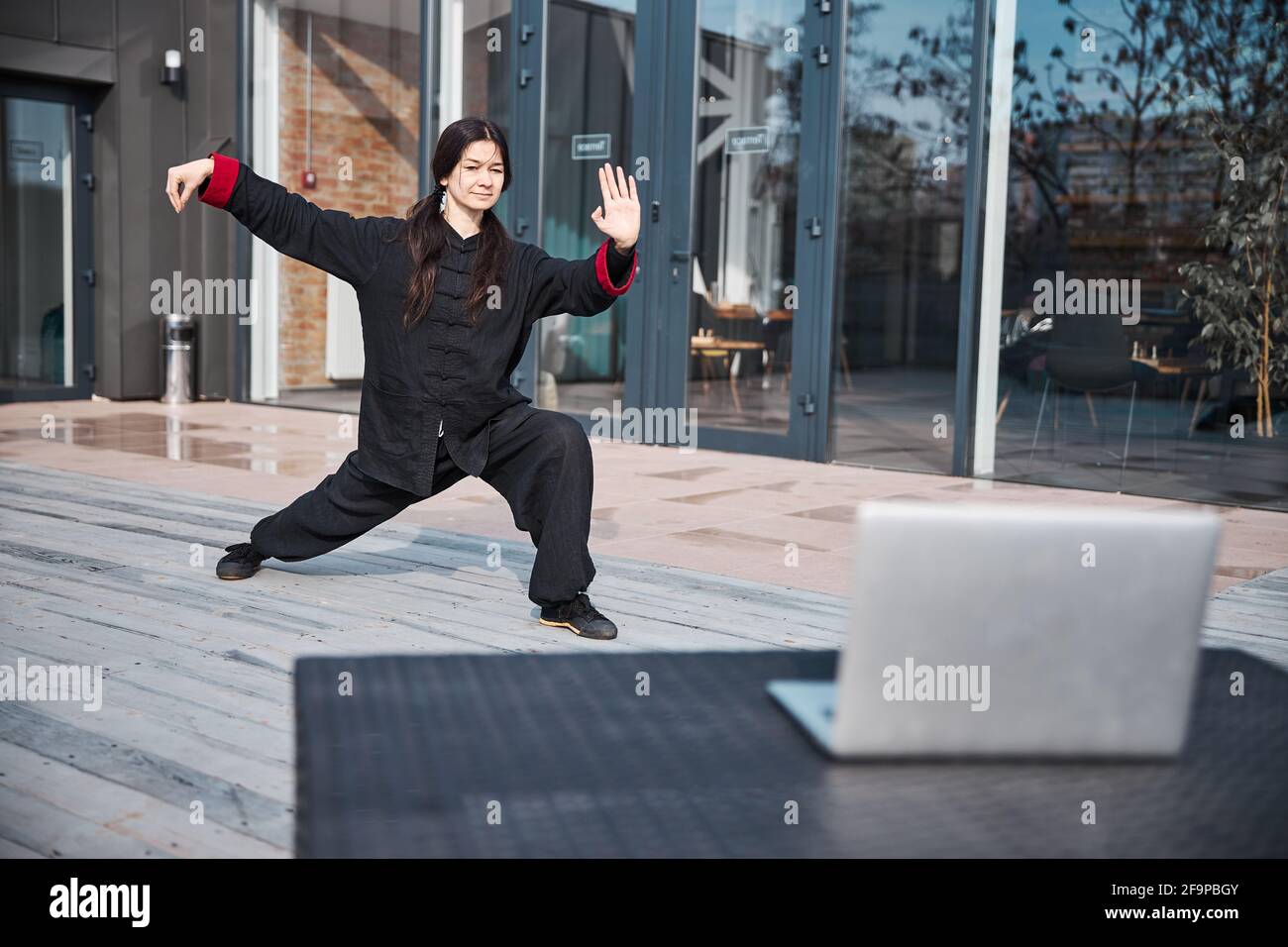 Taijiquan form in front stance with stretched left hand Stock Photo - Alamy