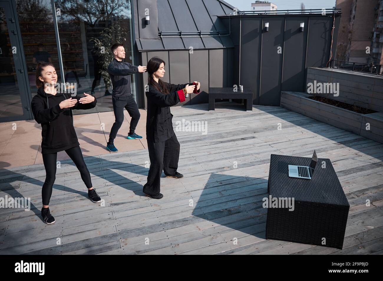 Relaxation activity in a group of three outdoors Stock Photo - Alamy