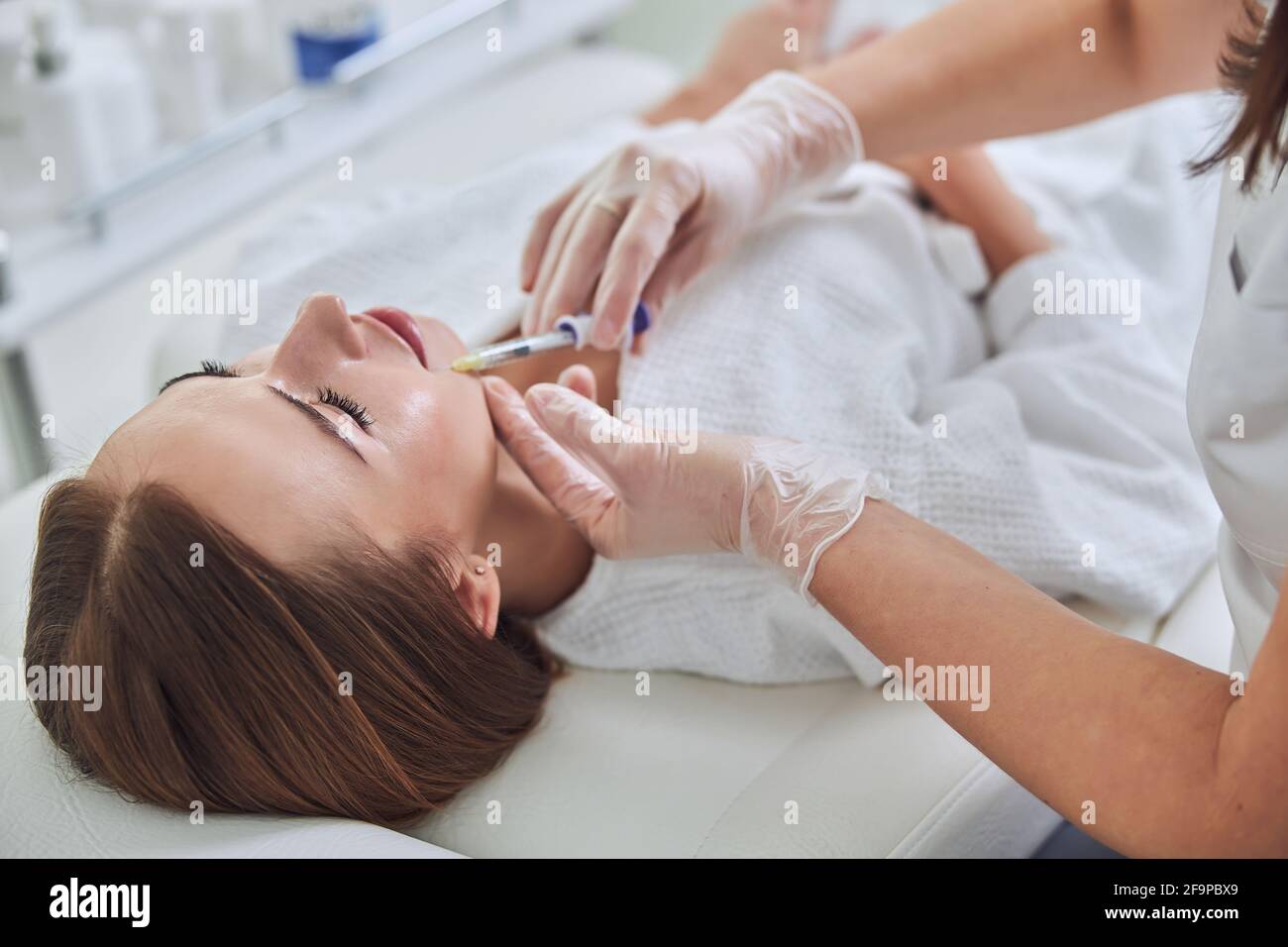Charming woman receiving beauty injection in spa salon Stock Photo - Alamy