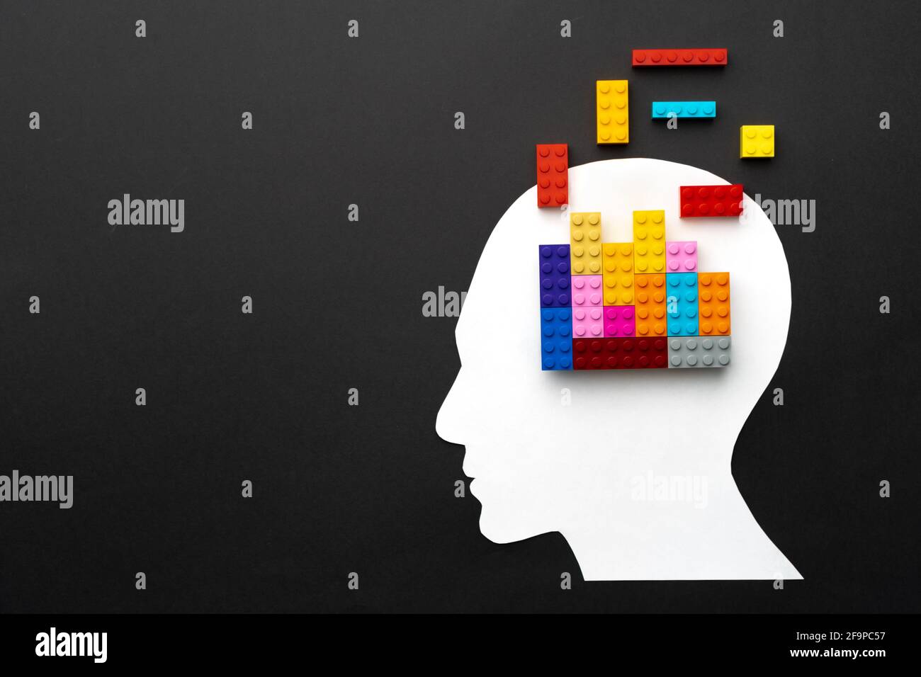 Papercut silhouette of human head with colorful constructor pieces ...