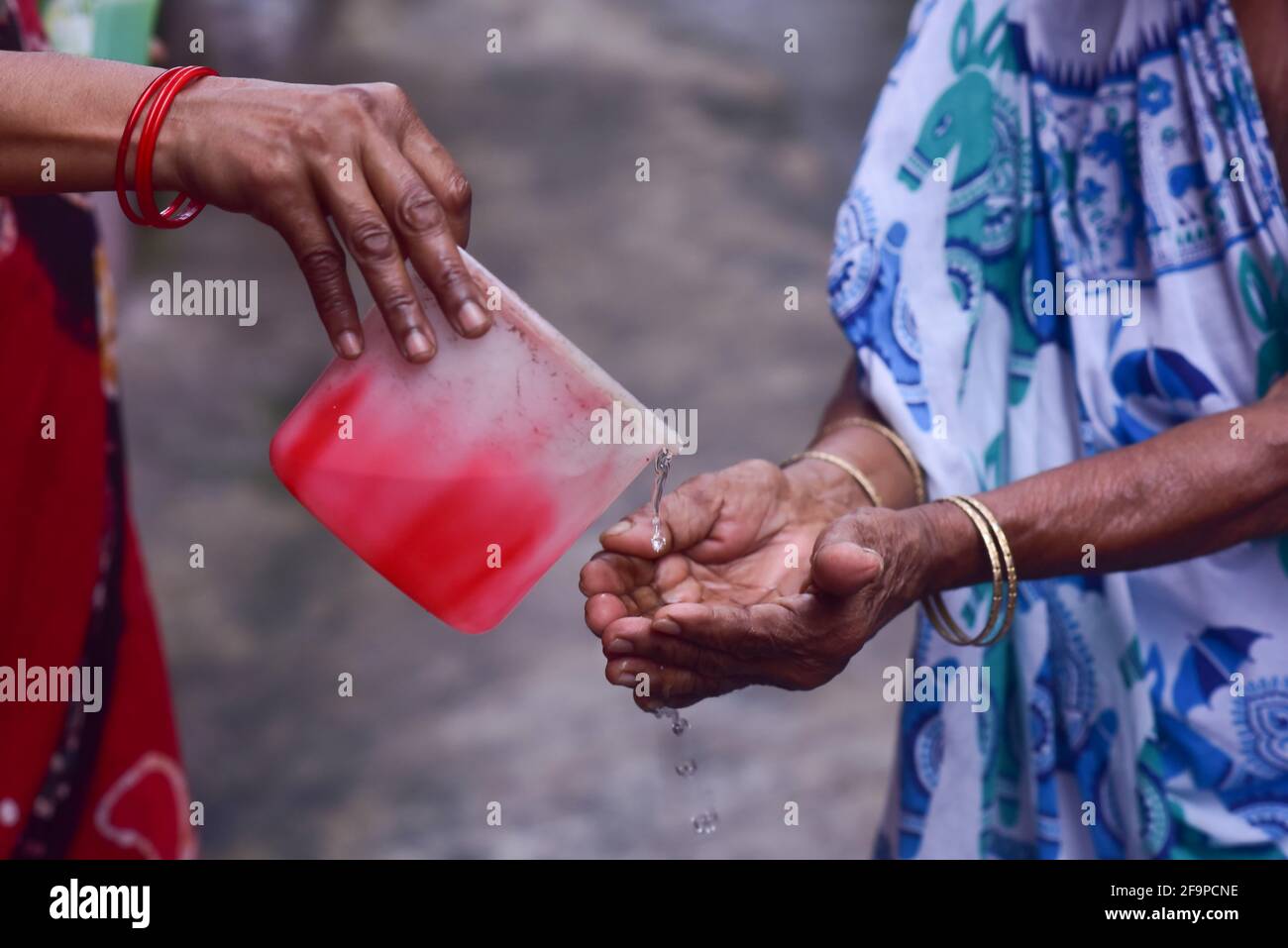 Old Indian woman washing her hands Stock Photo - Alamy