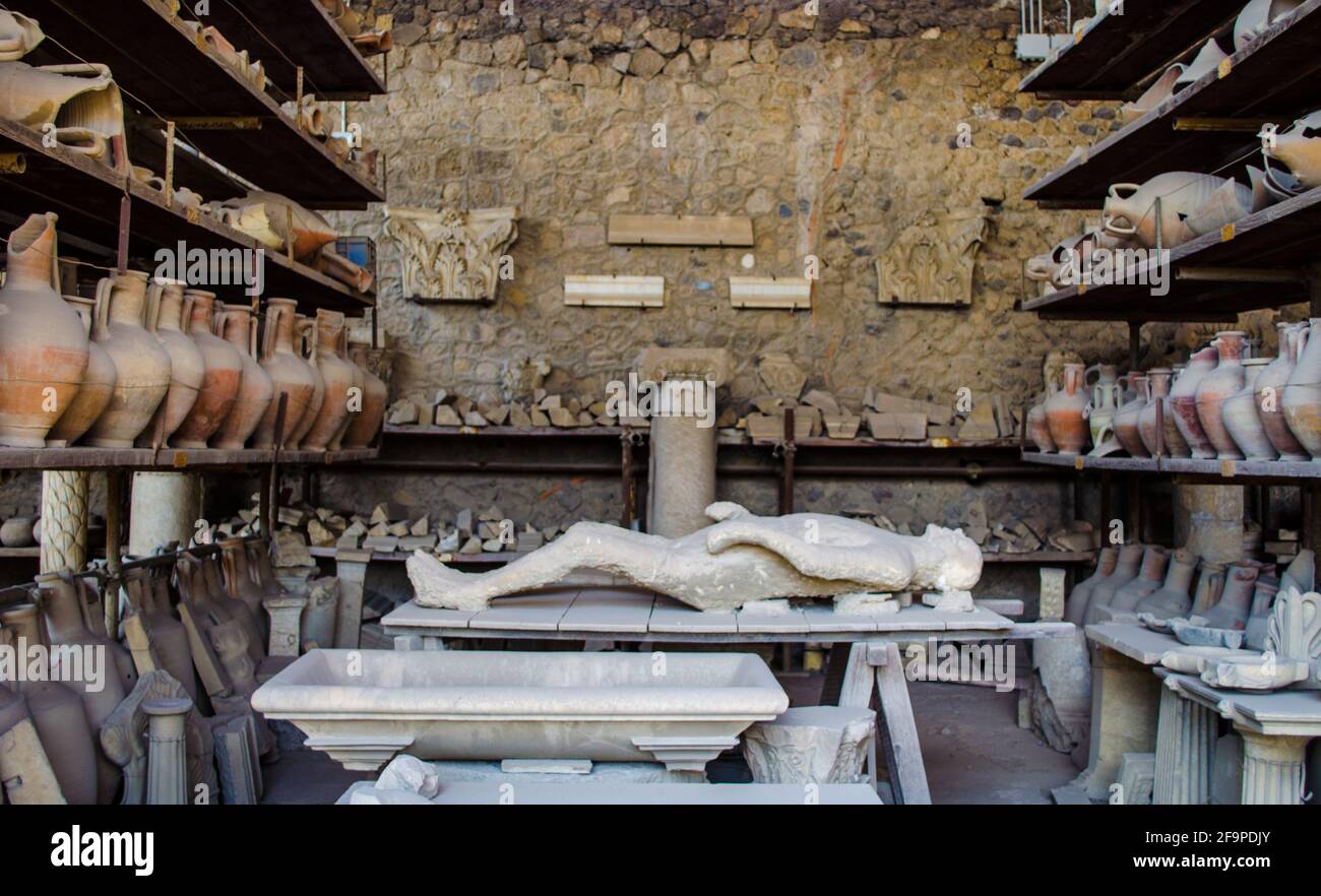 detail of a petrified corpse inside of area of ruins of the pompeii ...