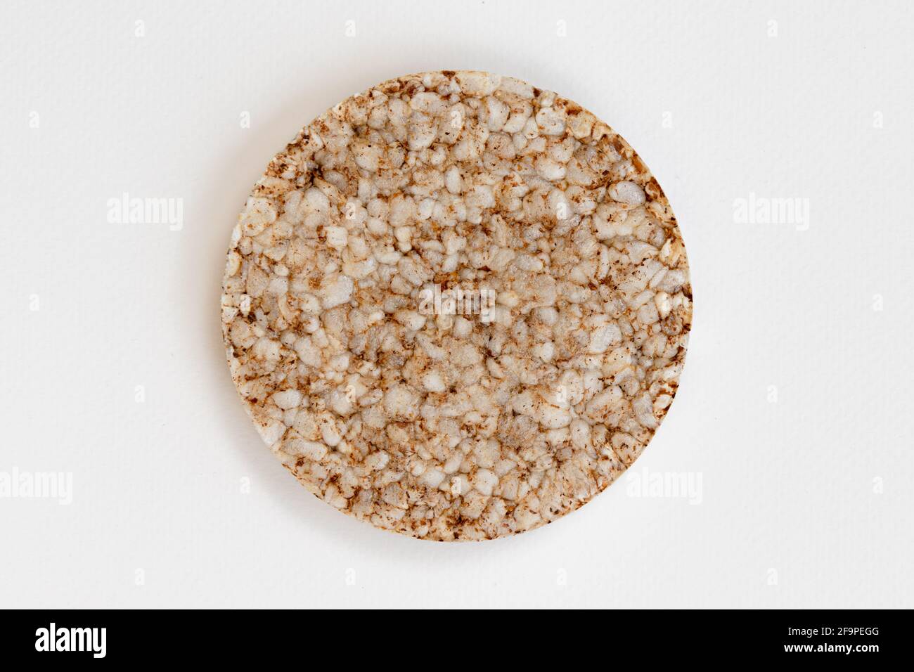 single rice cake isolated on white background, top view of puffed ...