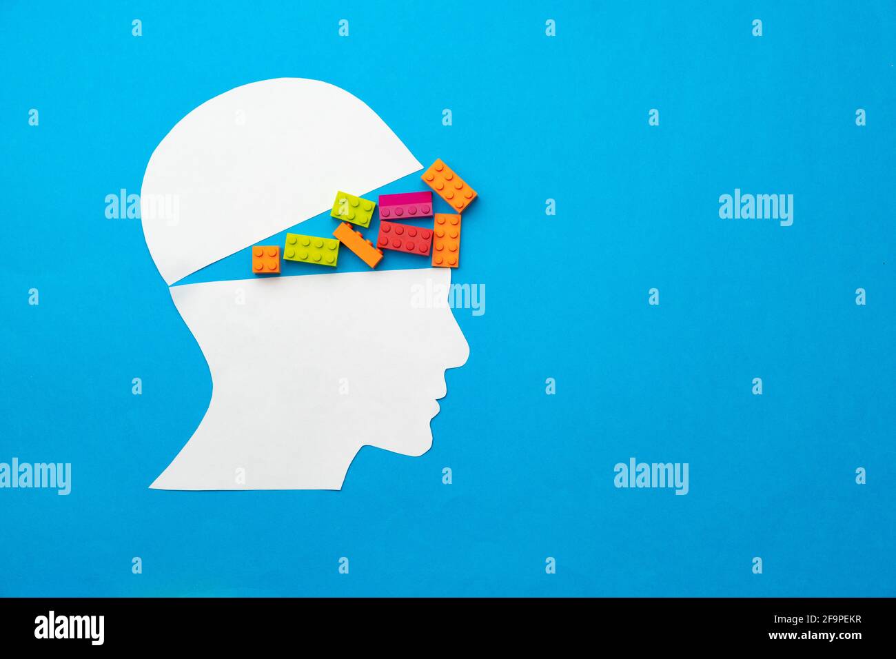 Papercut silhouette of human head with colorful constructor pieces ...